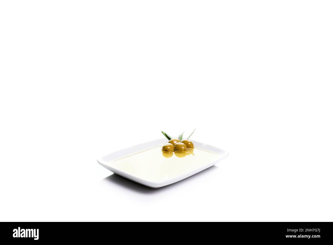 olive oil on plate isolated on white background Stock Photo - Alamy