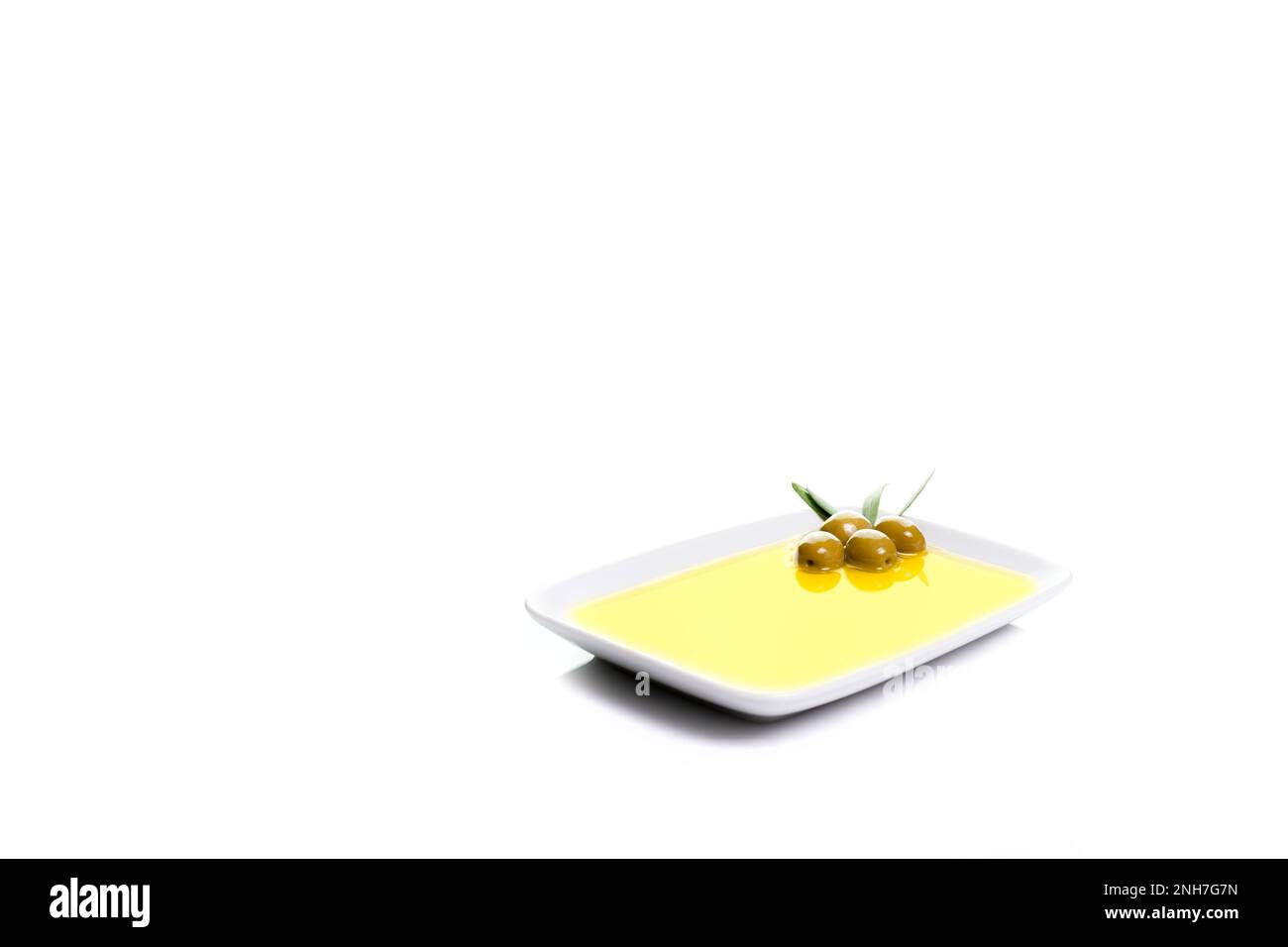 olive oil on plate isolated on white background Stock Photo - Alamy
