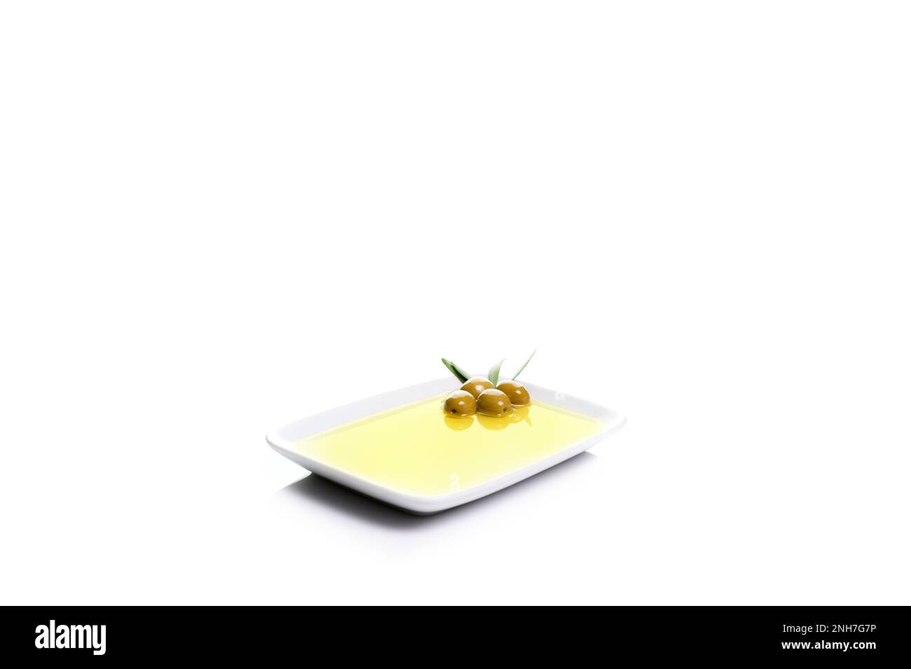 olive oil on plate isolated on white background Stock Photo - Alamy