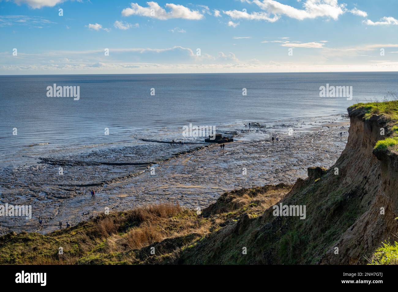 Looking out into the North Sea with the eroding cliffs of Walton on the ...