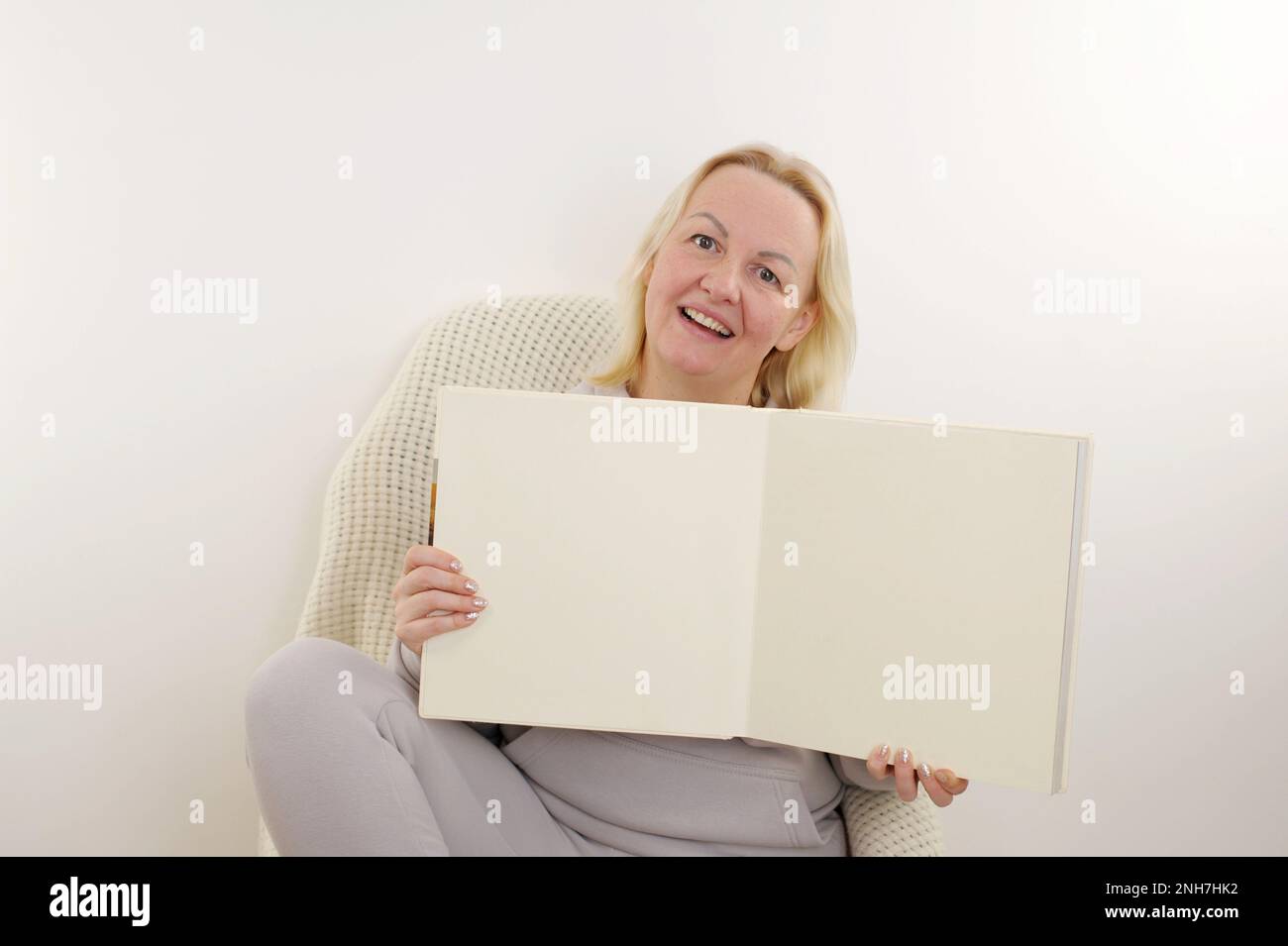 satisfied woman opened album empty space for advertising photos ...