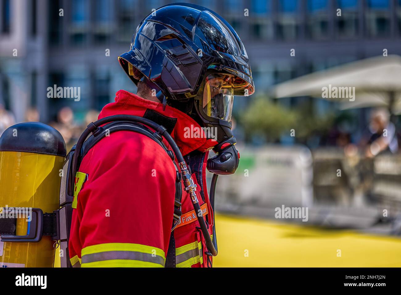 A professional fireman wearing a protective safety vest and a helmet ...