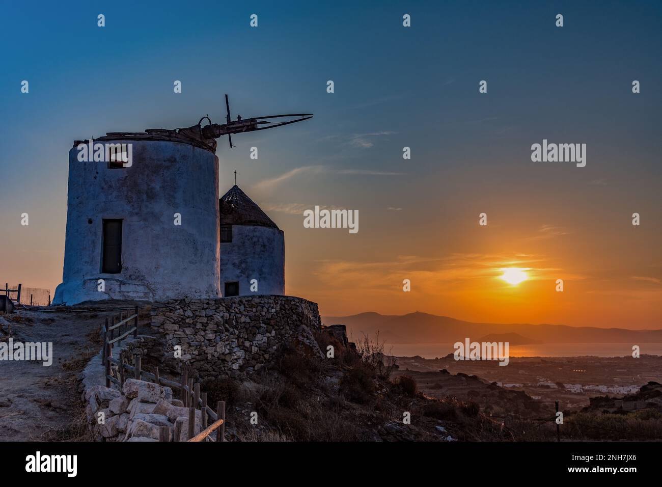 Traditional Cycladic windmills in Vivlos village at sunset, Naxos Stock ...