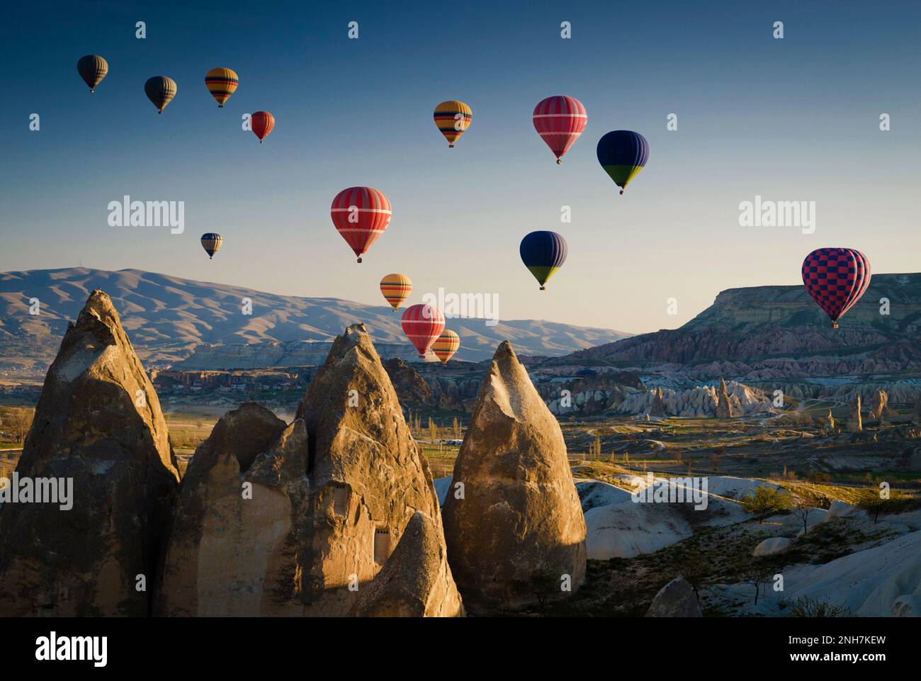 Touristic hot air balloons rising up all over the valley in Goreme ...