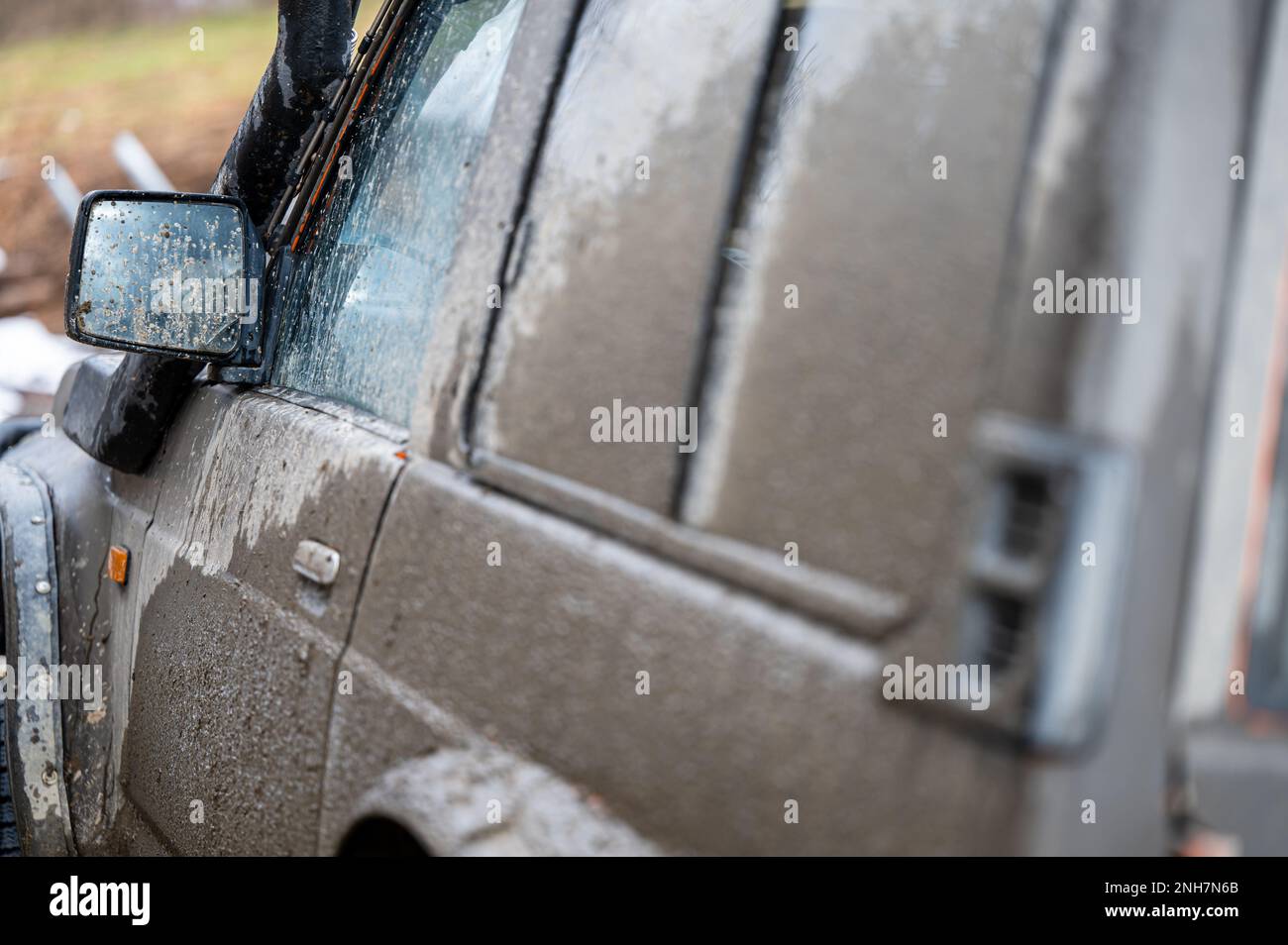 Mad splattered 4x4 SUV. Dirty car side. Splash and texture of mud on a ...