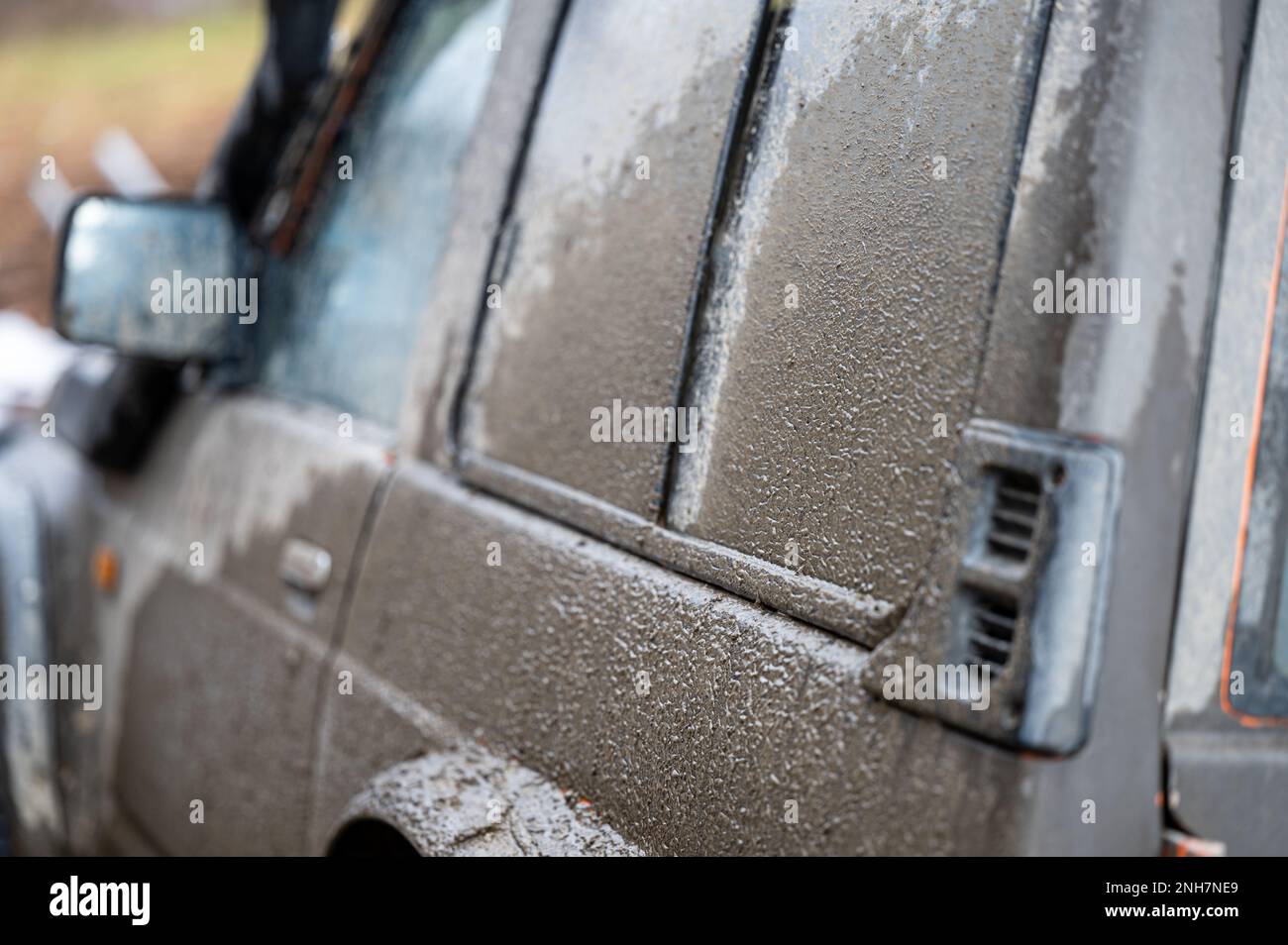 Mad splattered 4x4 SUV. Dirty car side. Splash and texture of mud on a ...
