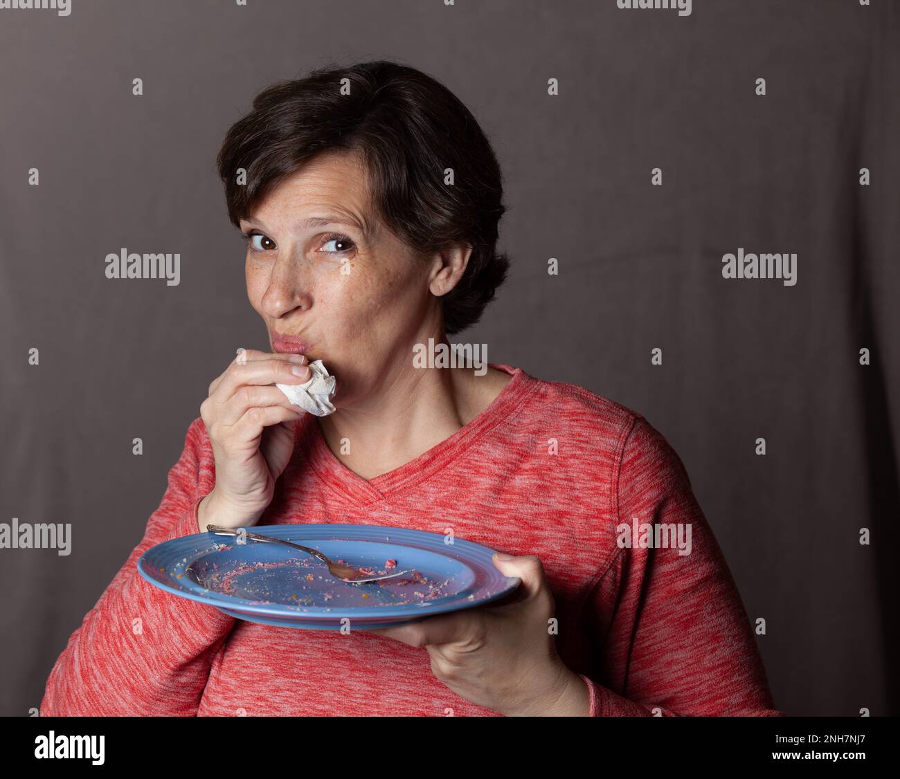 Older woman with an empty blue plate Stock Photo - Alamy