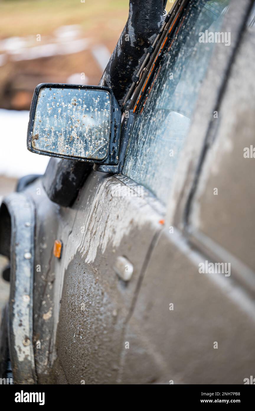 Mad splattered 4x4 SUV. Dirty car side. Splash and texture of mud on a ...