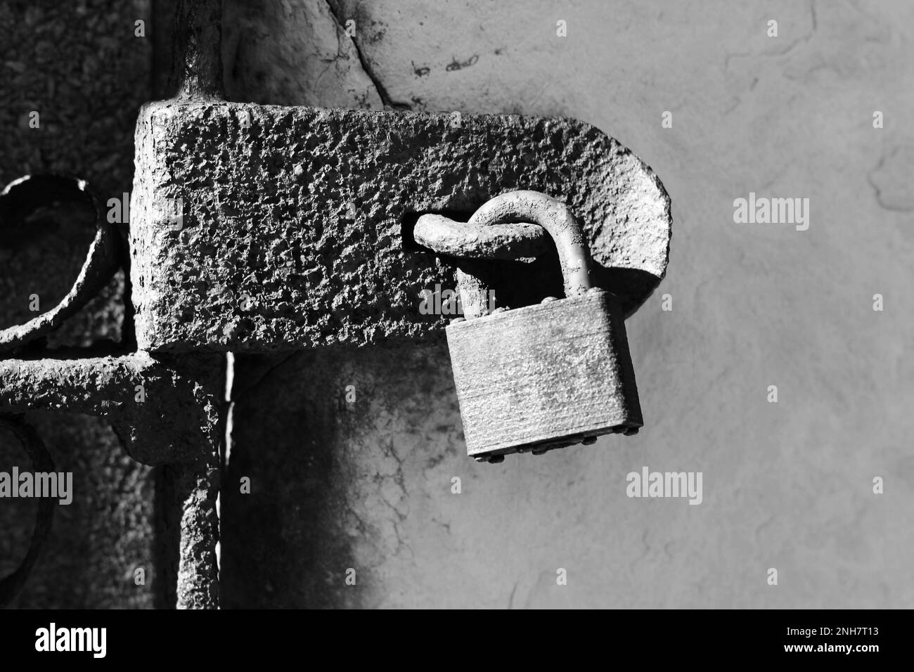 Vintage traditional old rusted metal lock keeping a gate closed in a ...