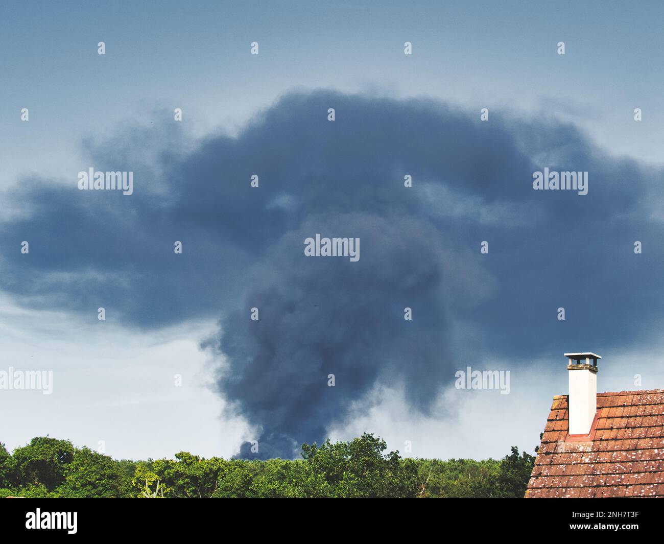 A Burning plastic recycling place causes a big pile of dark, black ...