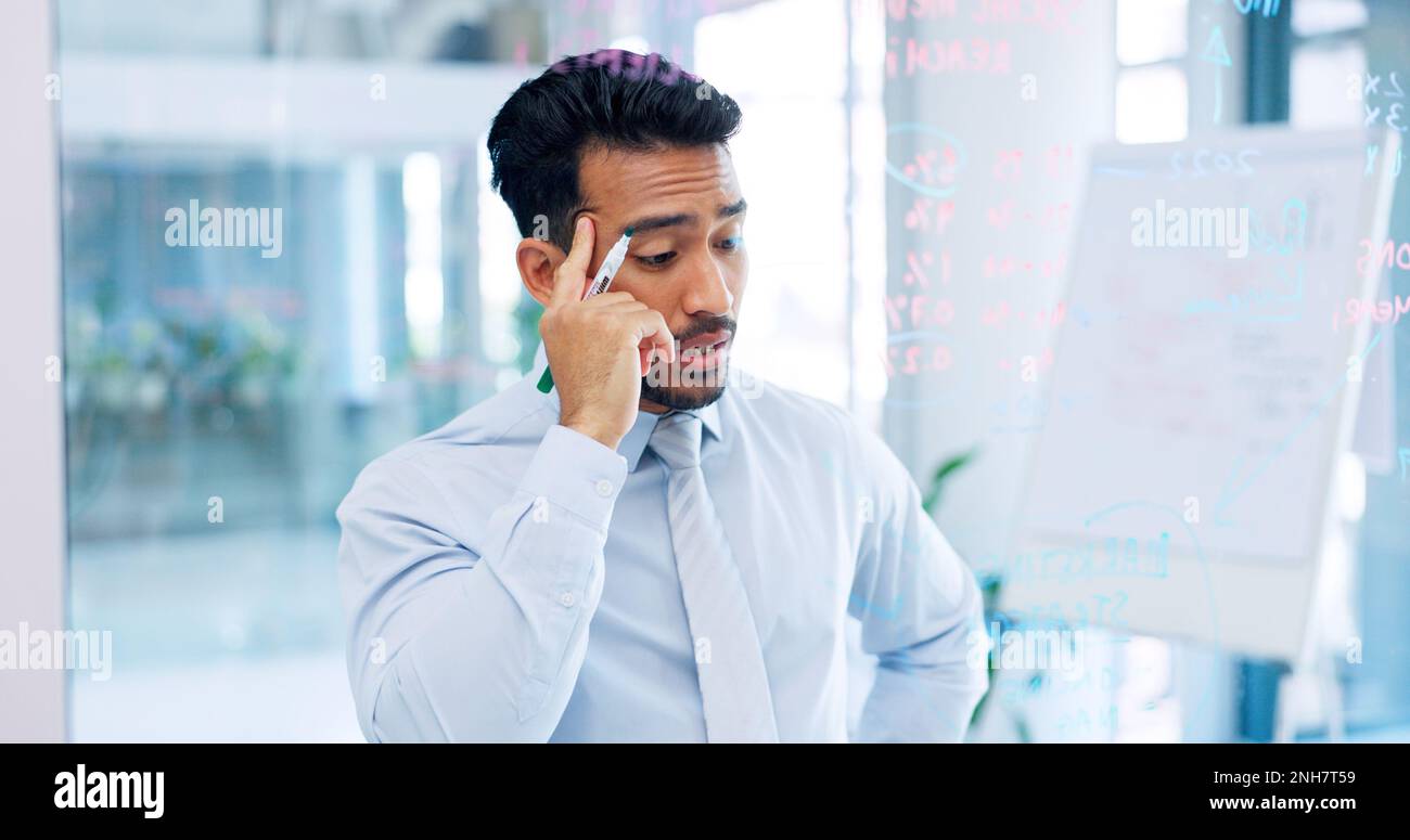 Thinking, strategy and serious businessman writing on glass wall with ...