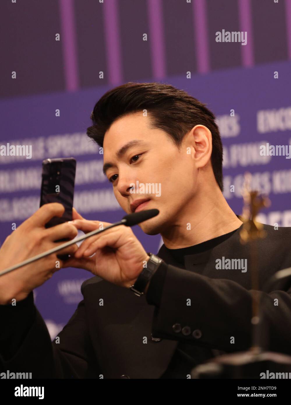 Berlin, Germany. 19th February 2023. Actor Teo Yoo taking a photo at ...