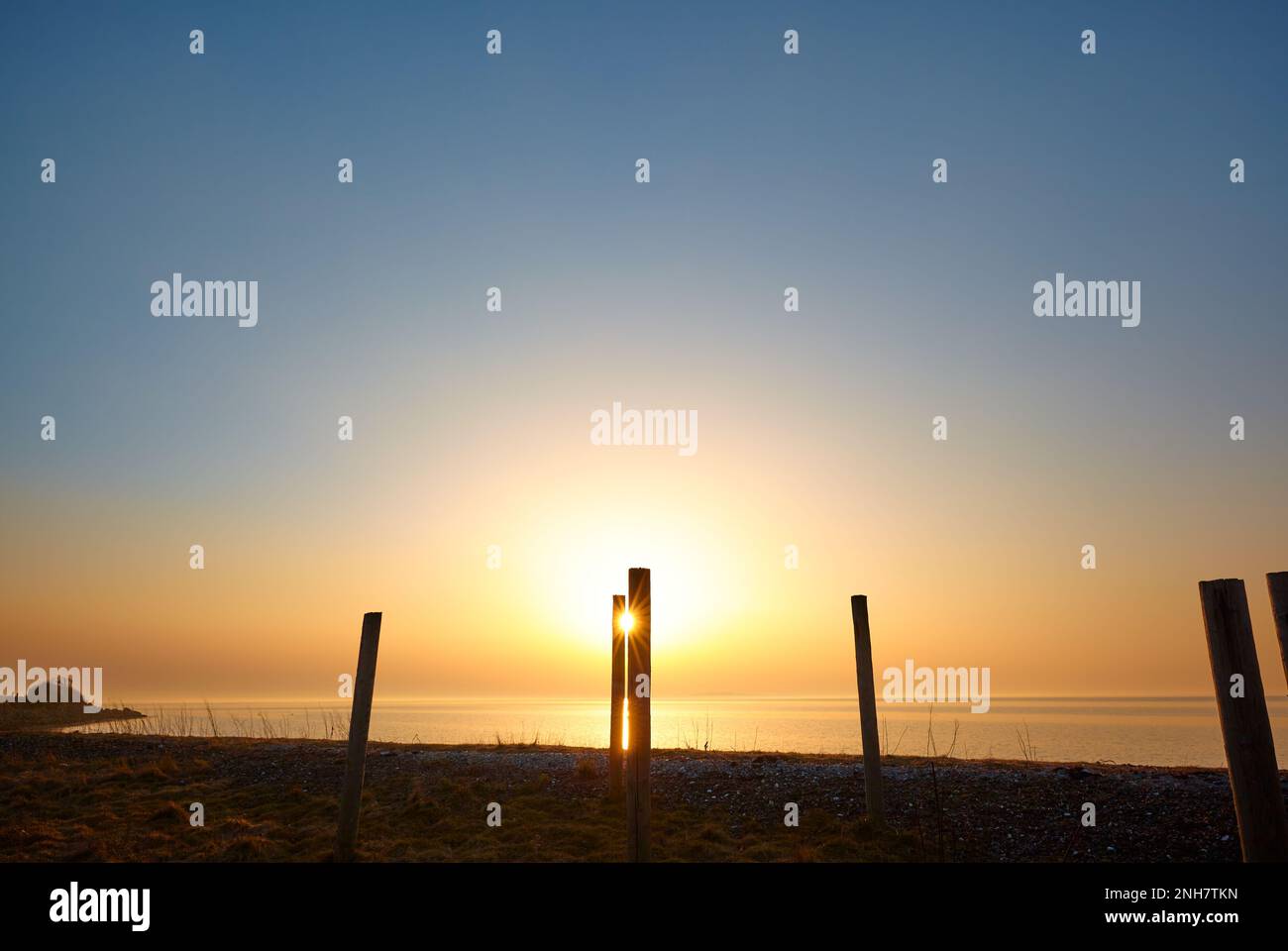 Amazing sunset on the beach, orange and blue colors, bright light ...