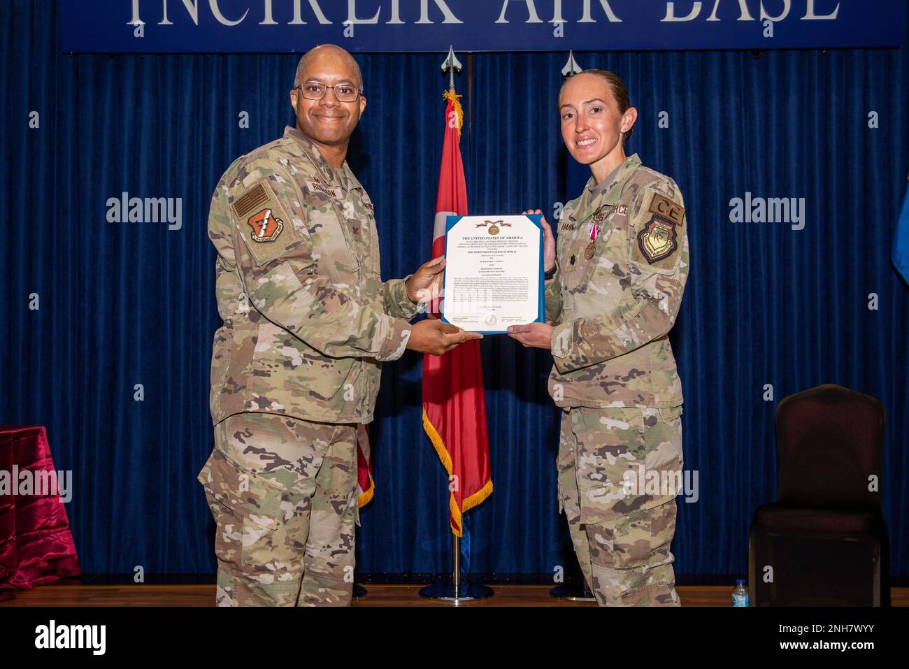 Lt. Col Marie T. Harnly receives a meritorious service medal from Col ...