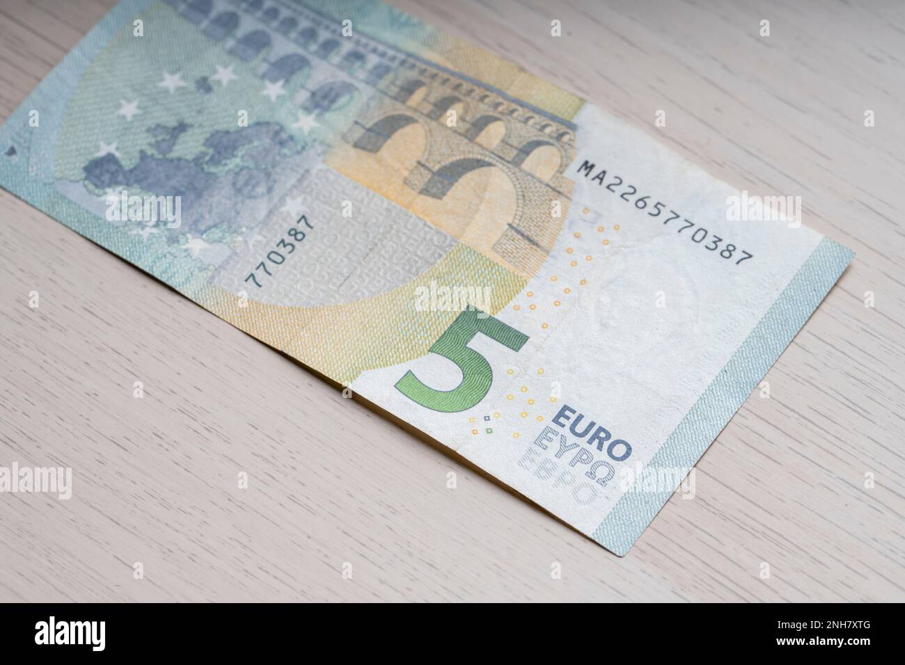 5 euro banknote close up, wooden table background for business finance ...