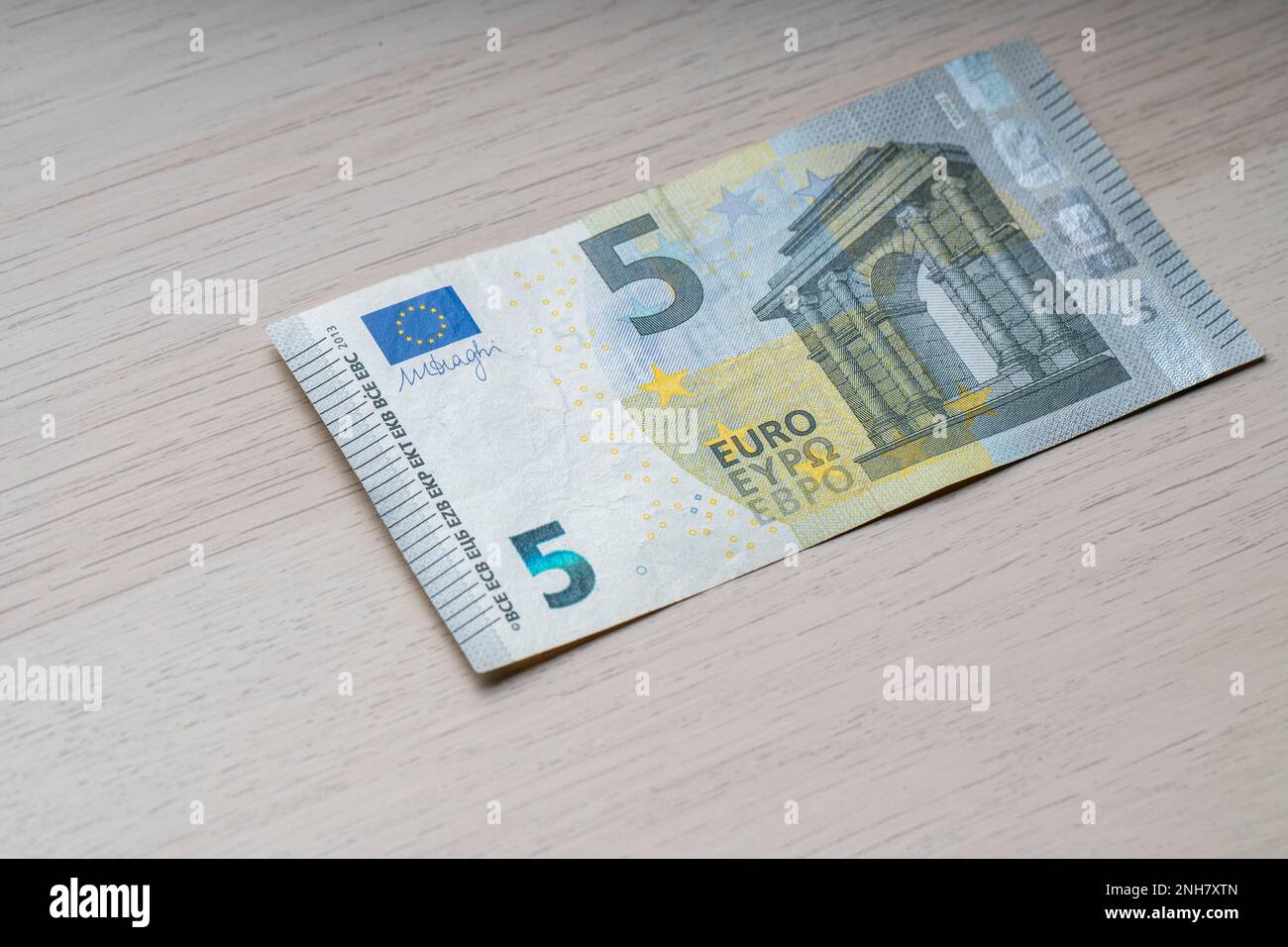 5 euro banknote close up, wooden table background for business finance ...