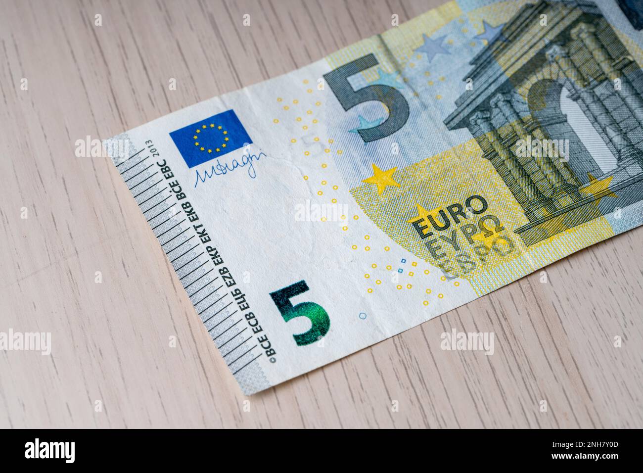 5 euro banknote close up, wooden table background for business finance ...