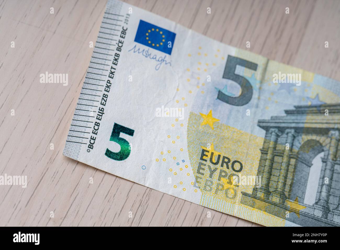 5 euro banknote close up, wooden table background for business finance ...