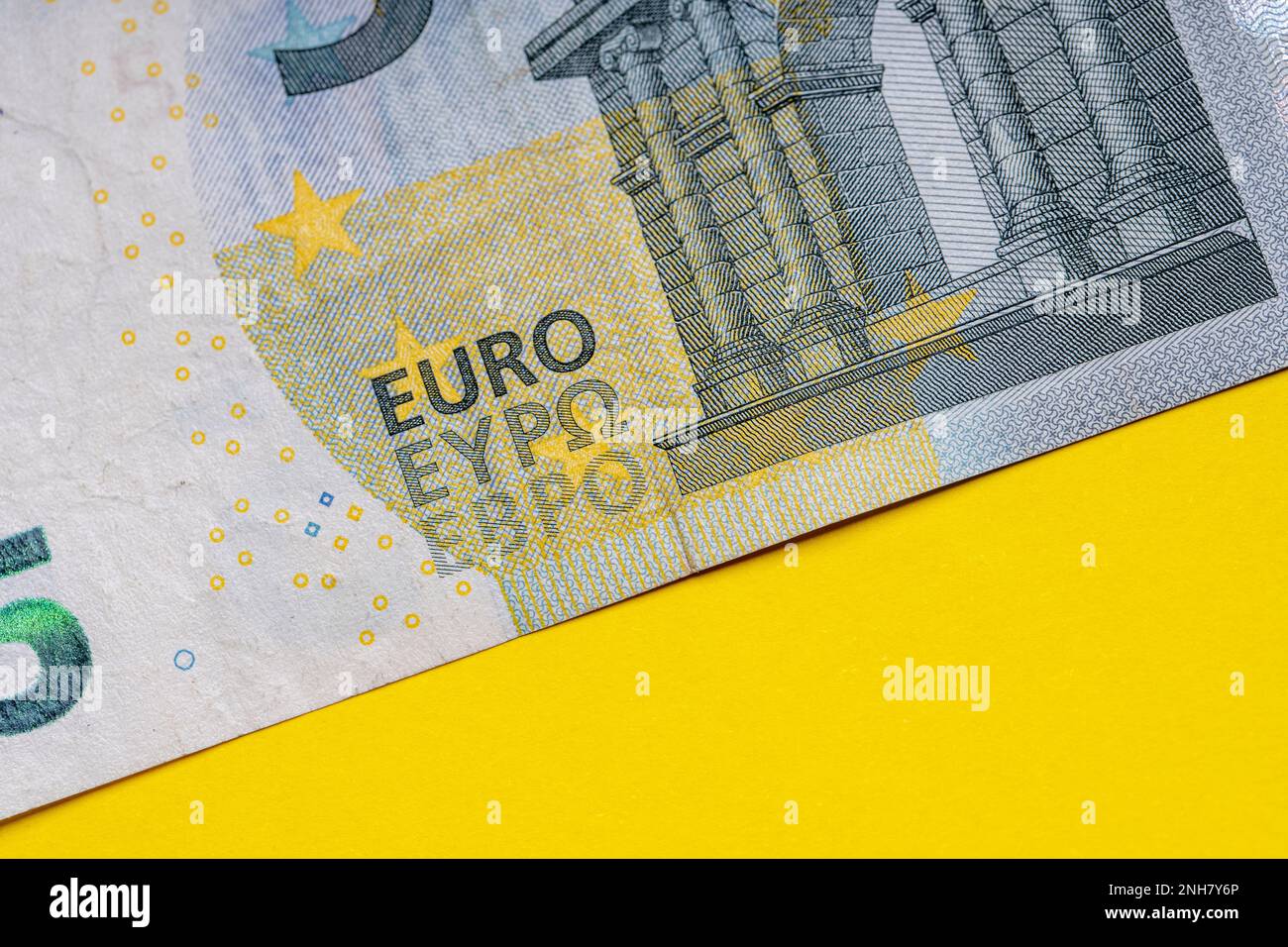 5 euro banknote close up, yellow background for business finance topics ...