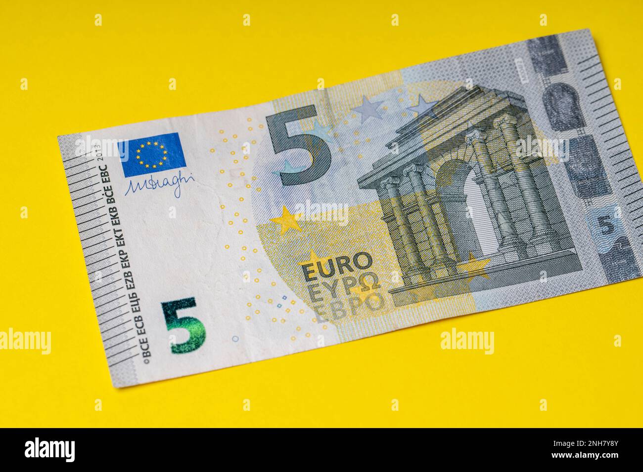 5 euro banknote close up, yellow background for business finance topics ...