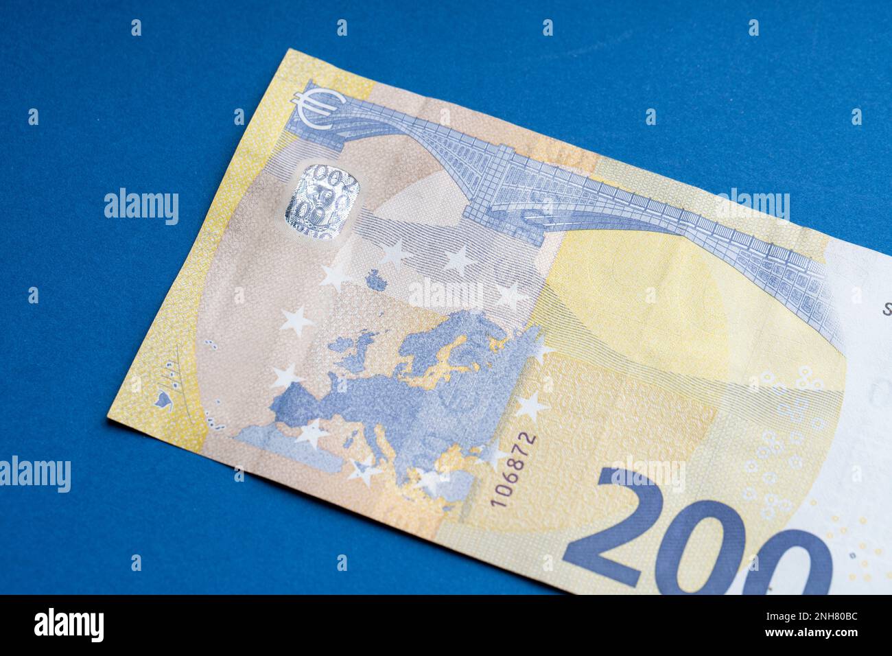 200 euro banknote close up, blue background for business finance topics ...