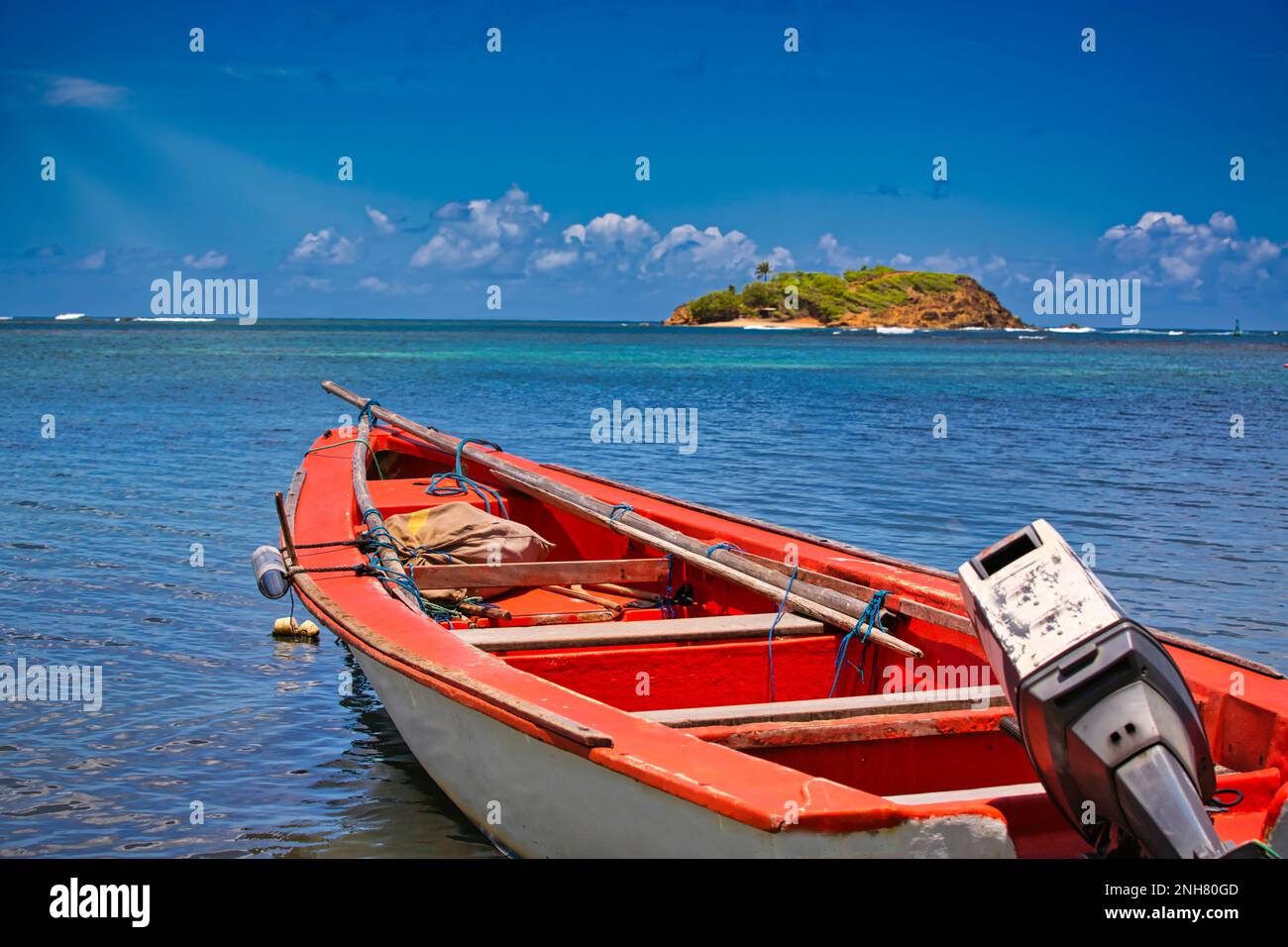 Small wooden colorful boat on crystal blue water ocean at gold time ...