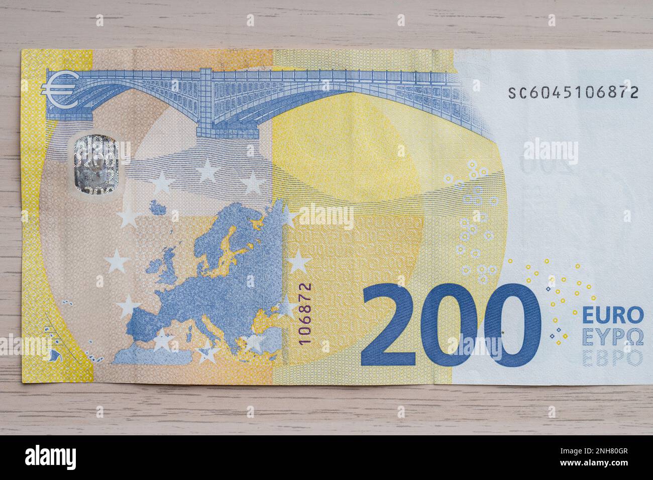 200 euro banknote close up, wooden table background for business ...