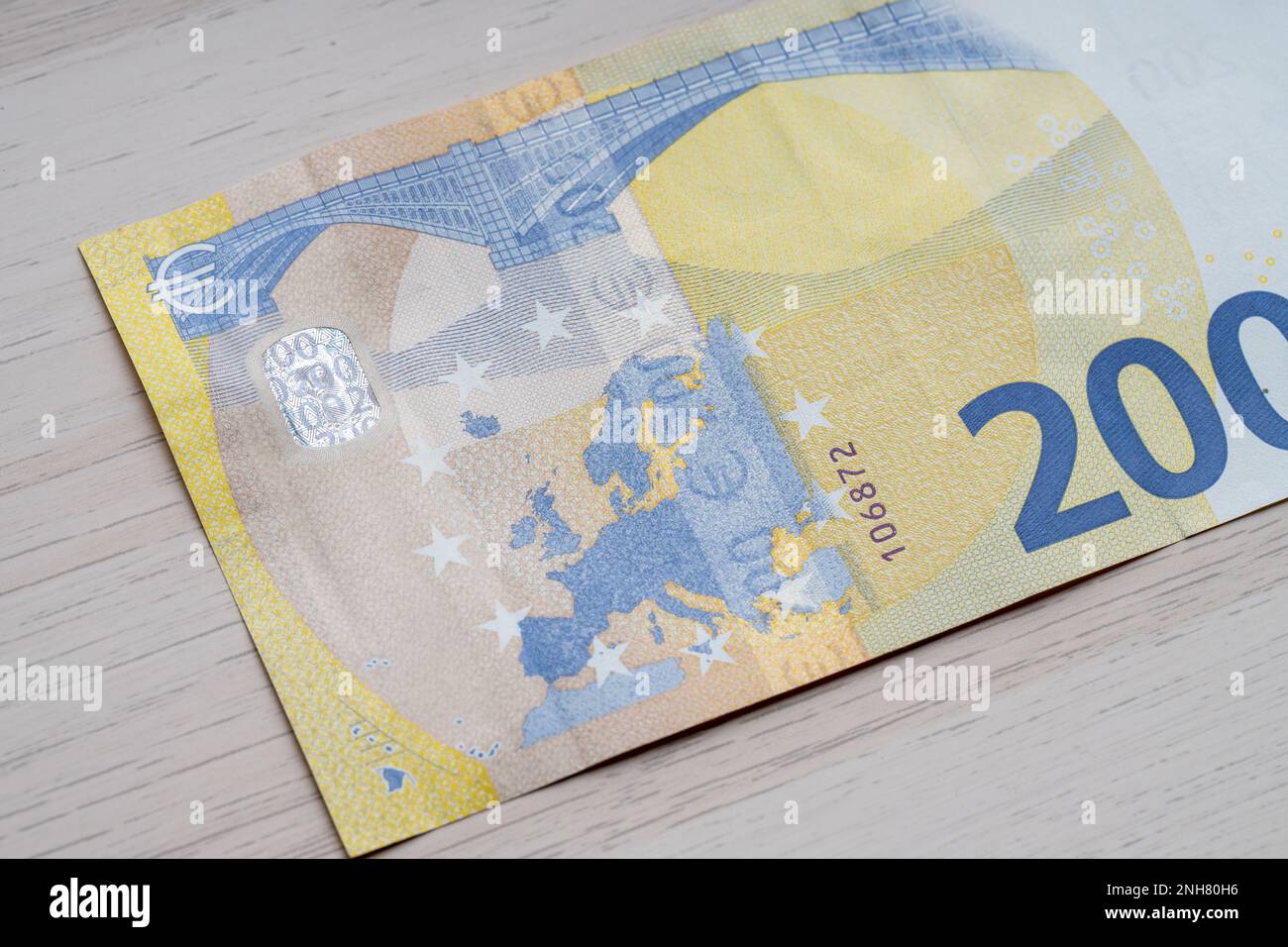 200 euro banknote close up, wooden table background for business ...