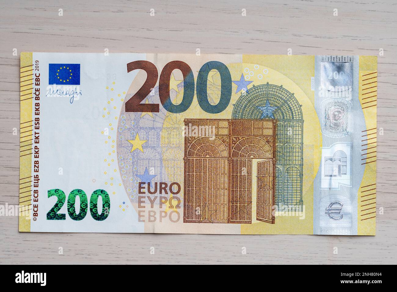 200 euro banknote close up, wooden table background for business ...