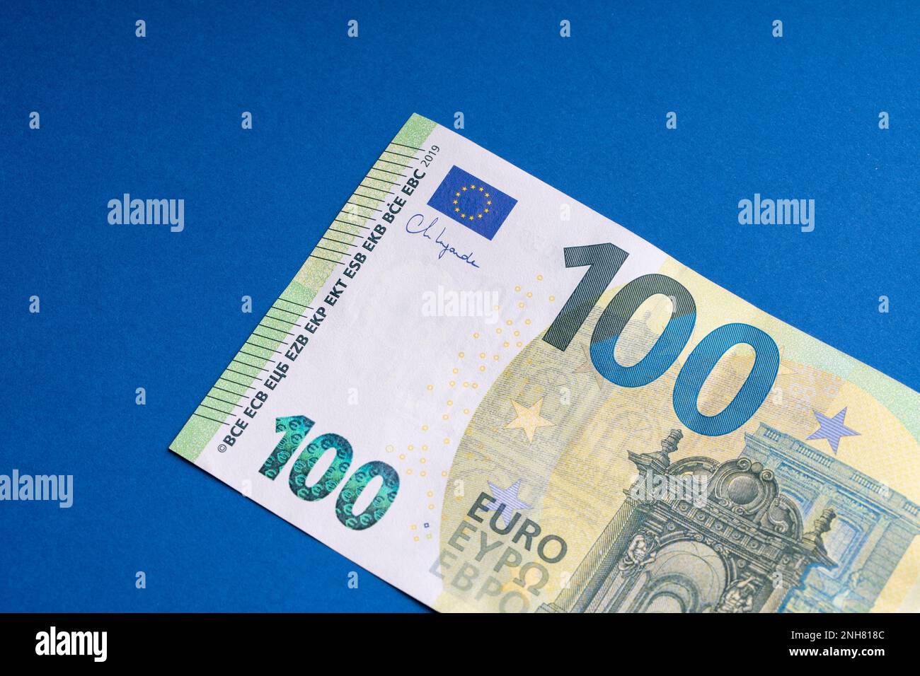 100 euro banknote close up, blue background for business finance topics ...