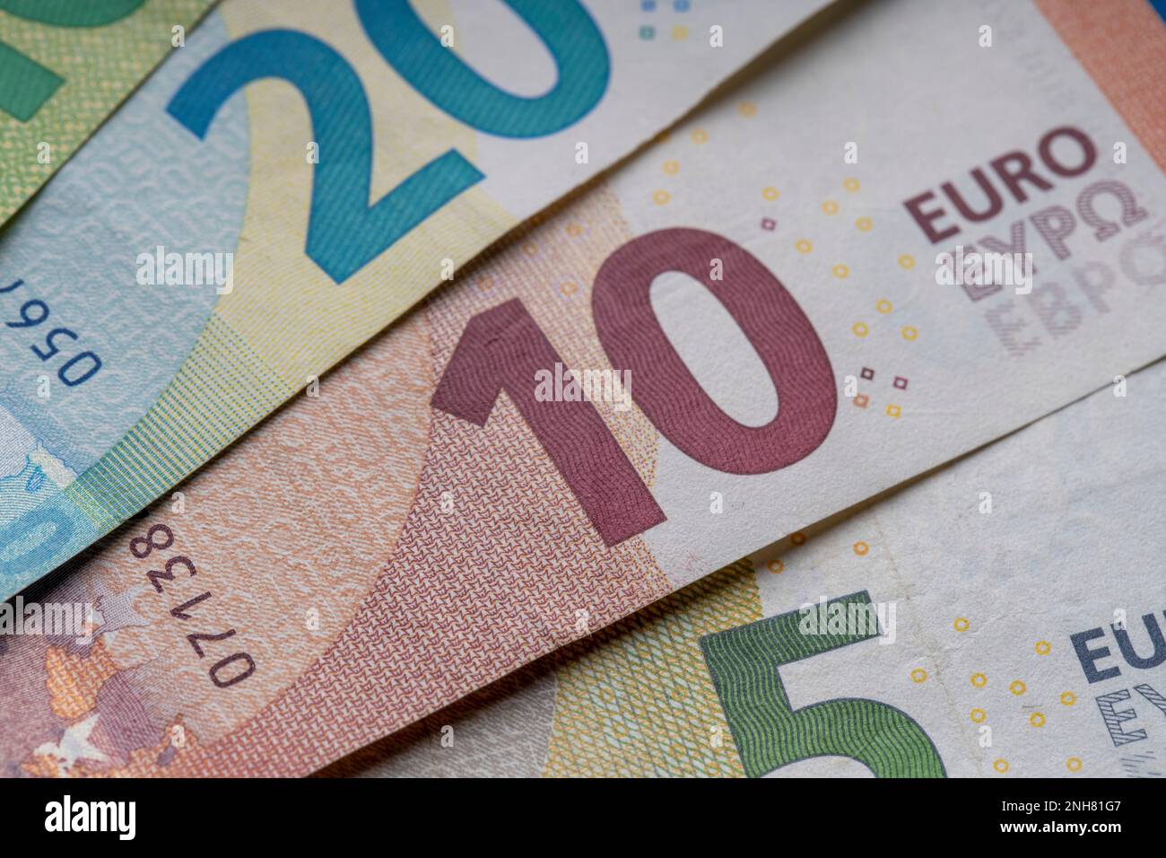 Different euro banknotes in a row close up, blue background for ...