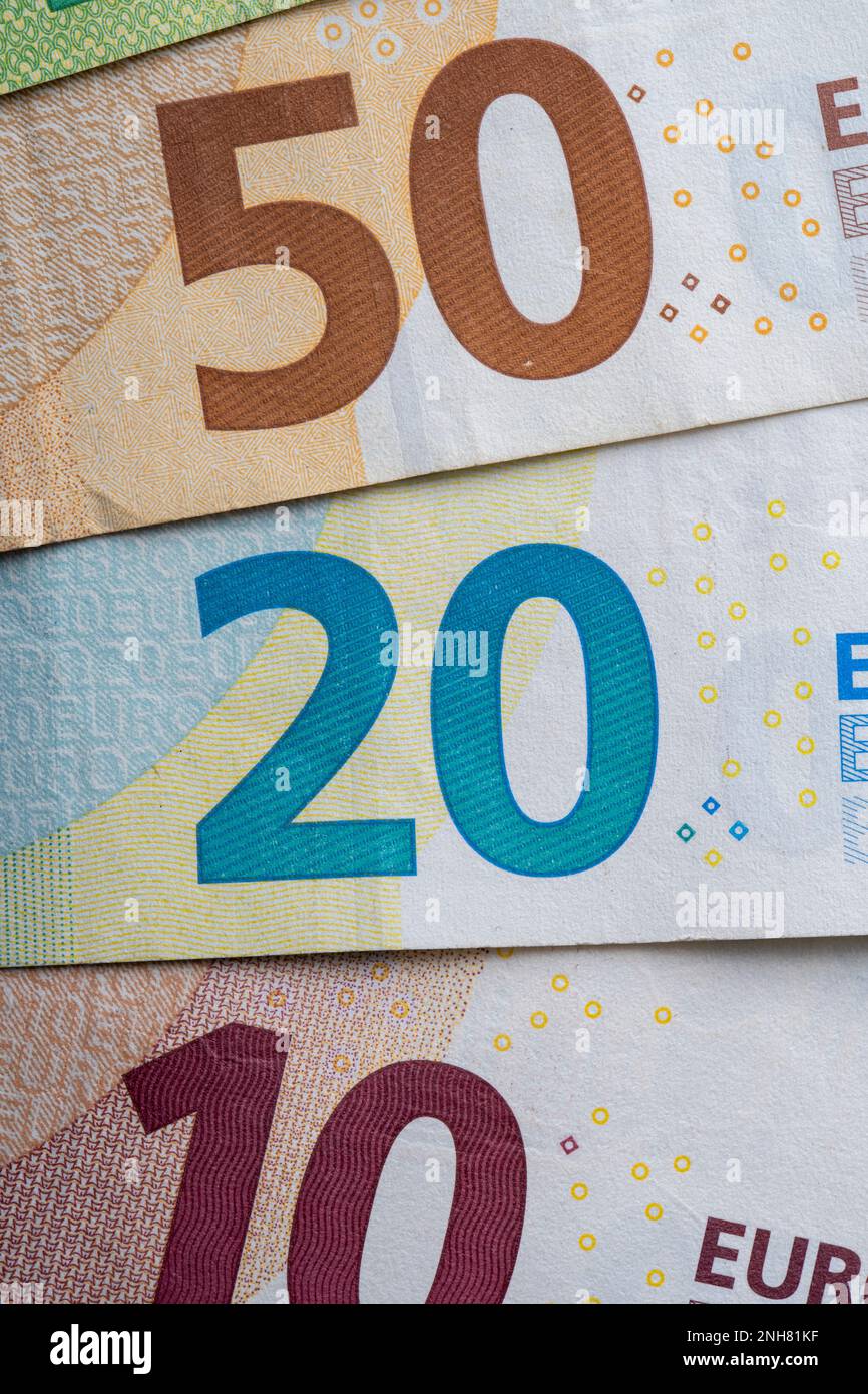Different euro banknotes in a row close up, blue background for ...