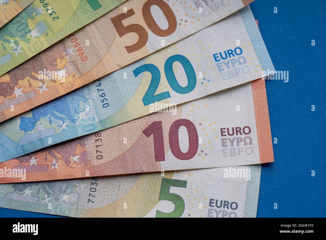 Different euro banknotes in a row close up, blue background for ...