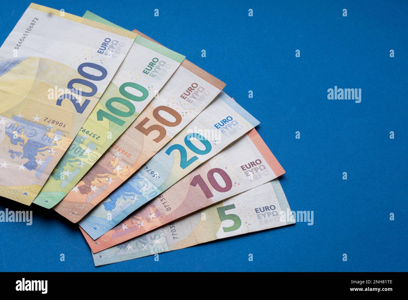 Different euro banknotes in a row close up, blue background for ...