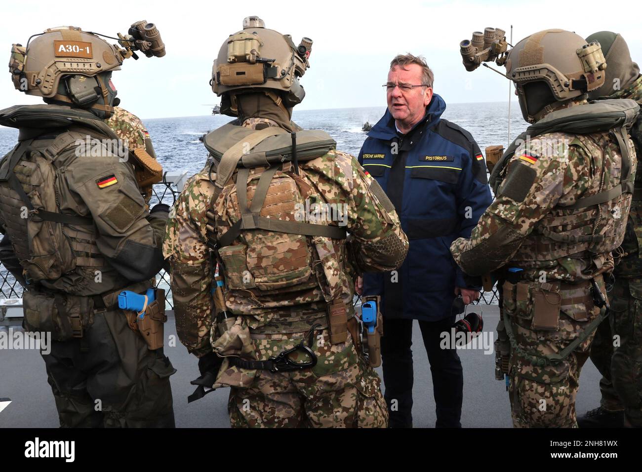 German Defence Minister Boris Pistorius, third left, talks to German ...