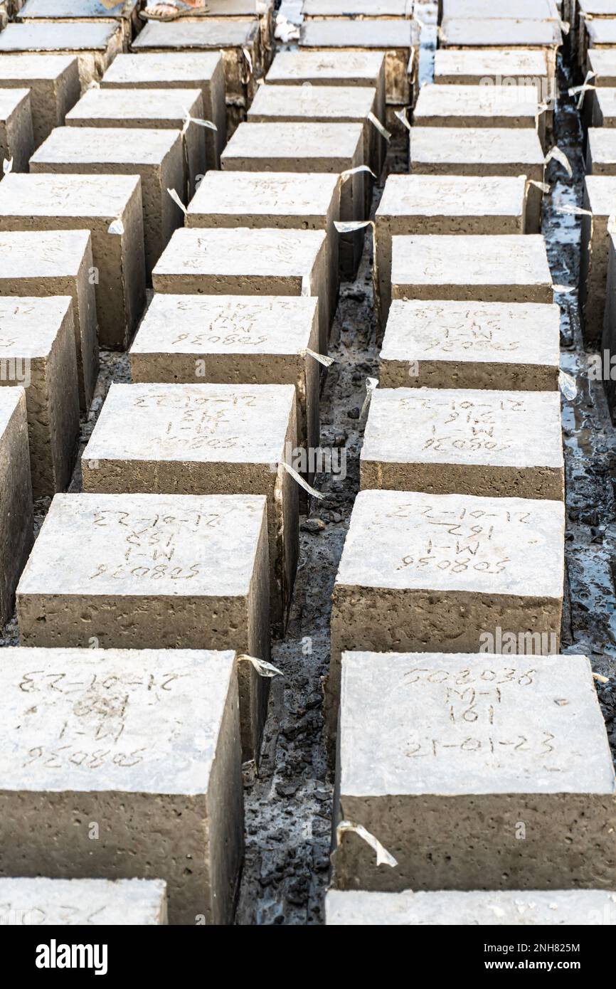 Portrait view of Rock bolder. Concrete cube over block background. Four square cinder blocks in ...
