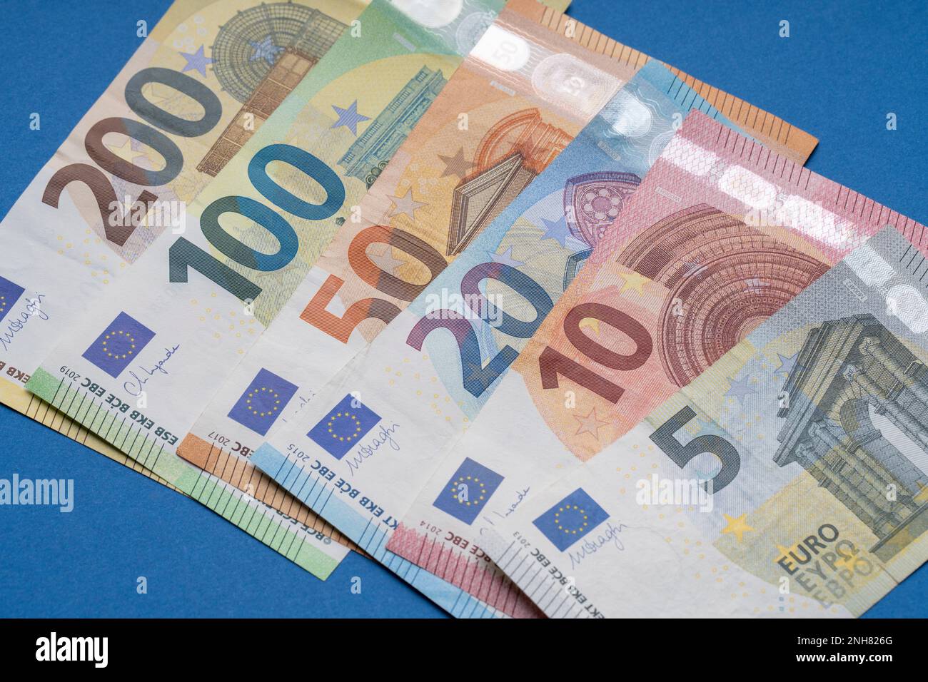 Different euro banknotes in a row close up, blue background for ...