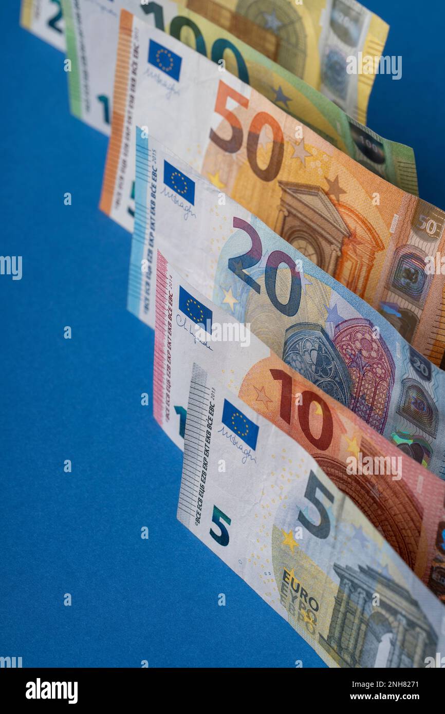 Different euro banknotes in a row close up, blue background for ...