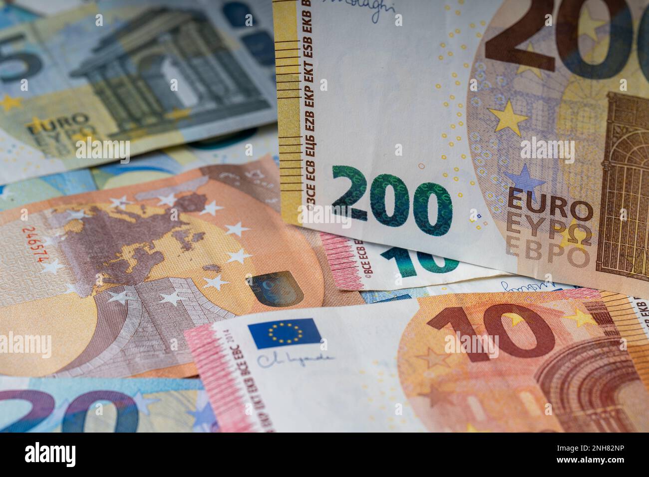 A pile of banknotes on the table. Two hundred euro paper money ...