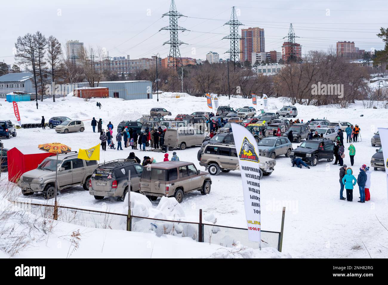 A large number of off-road cars are parked in the snow in winter Stock ...