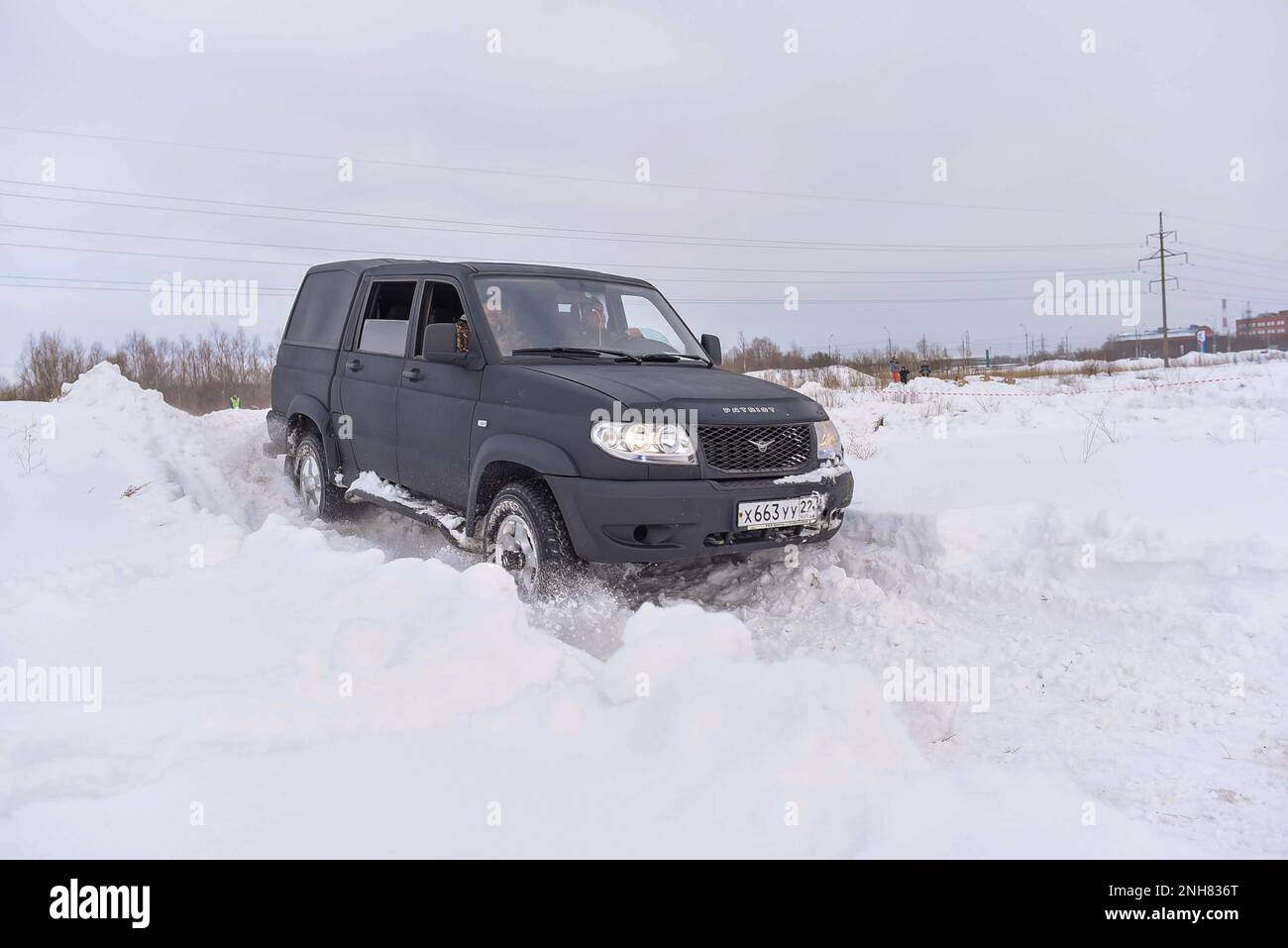Russian black SUV "UAZ Patriot" rides on a snow slide in winter Stock ...
