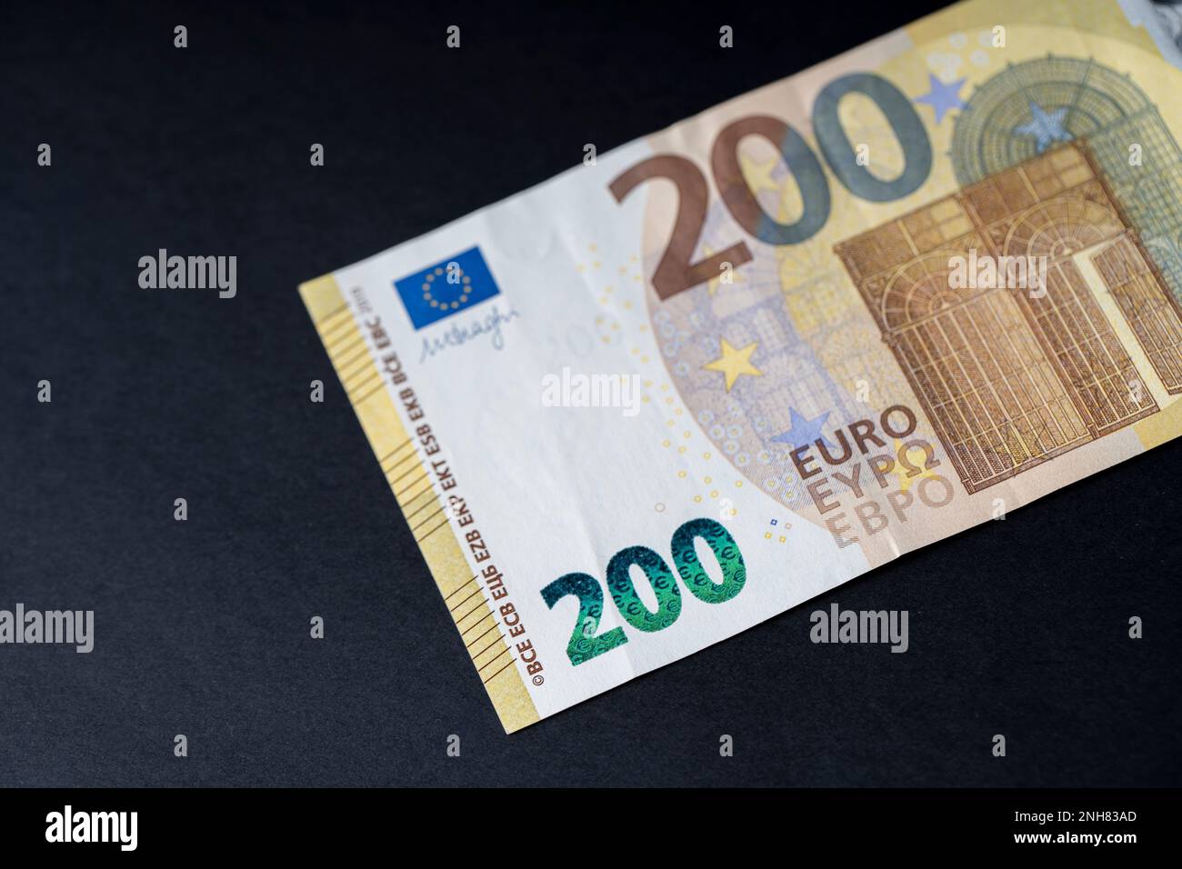 200 euro banknote close up on black background for business finance ...
