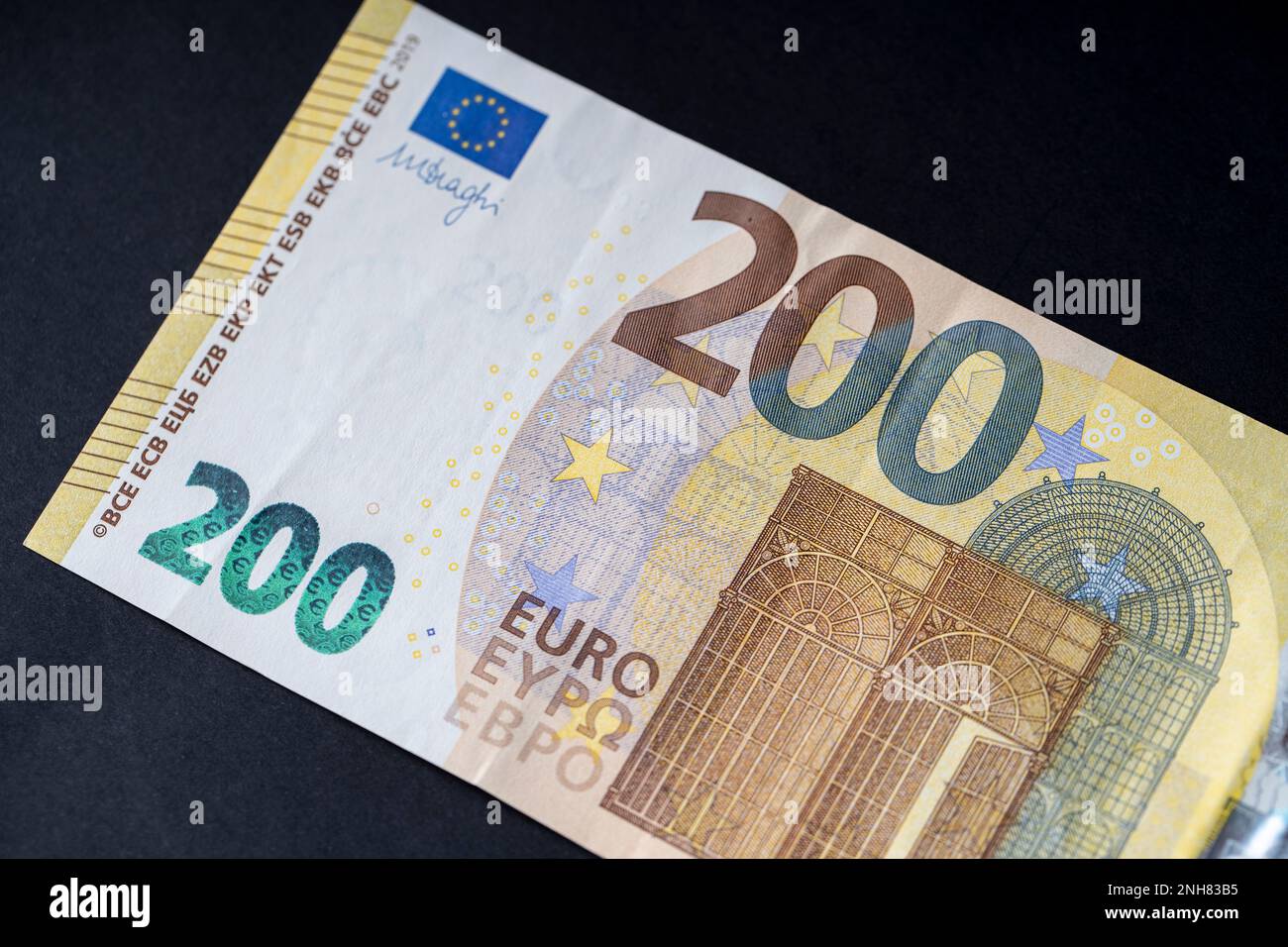 200 euro banknote close up on black background for business finance ...