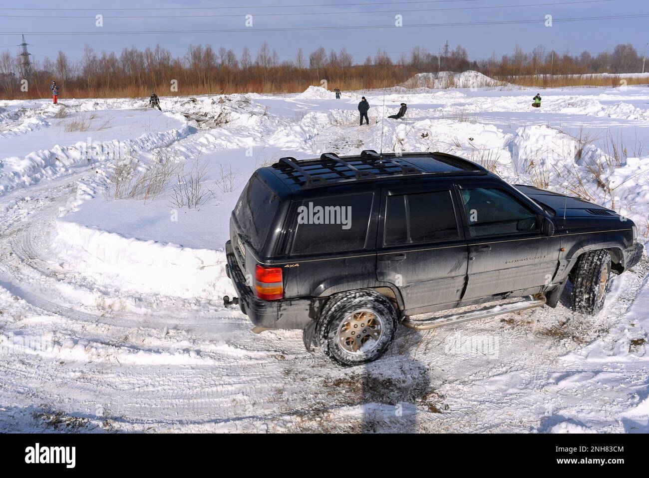 Offroad SUV "Jeep Grand Cherokee" 4x4 black color is fast driving on a ...