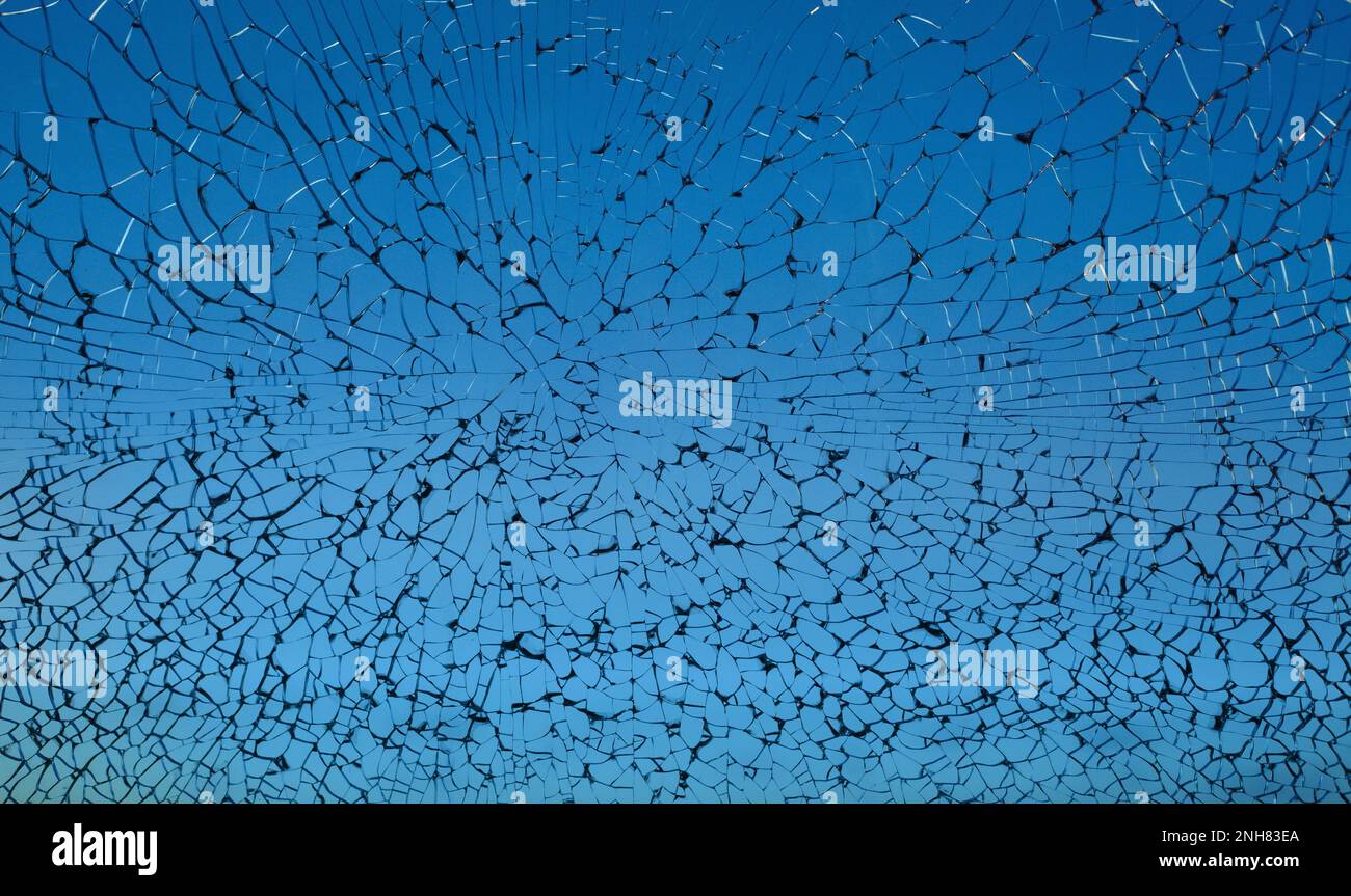 Blue broken shattered window glass with black cracks Stock Photo - Alamy