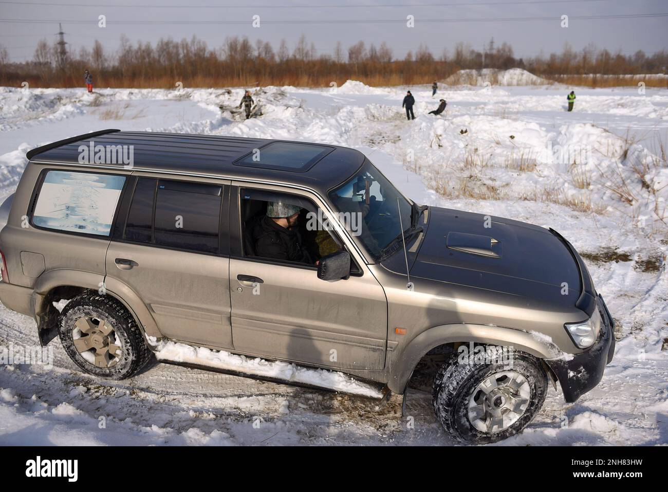 Offroad SUV "Nissan Patrol 4x4" quickly rides in the snow field in ...