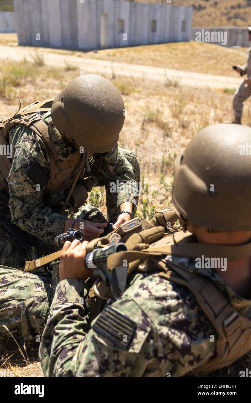 U.S. Naval Academy Midshipman Taylor Woodworth ties a tourniquet on a simulated casuality during ...