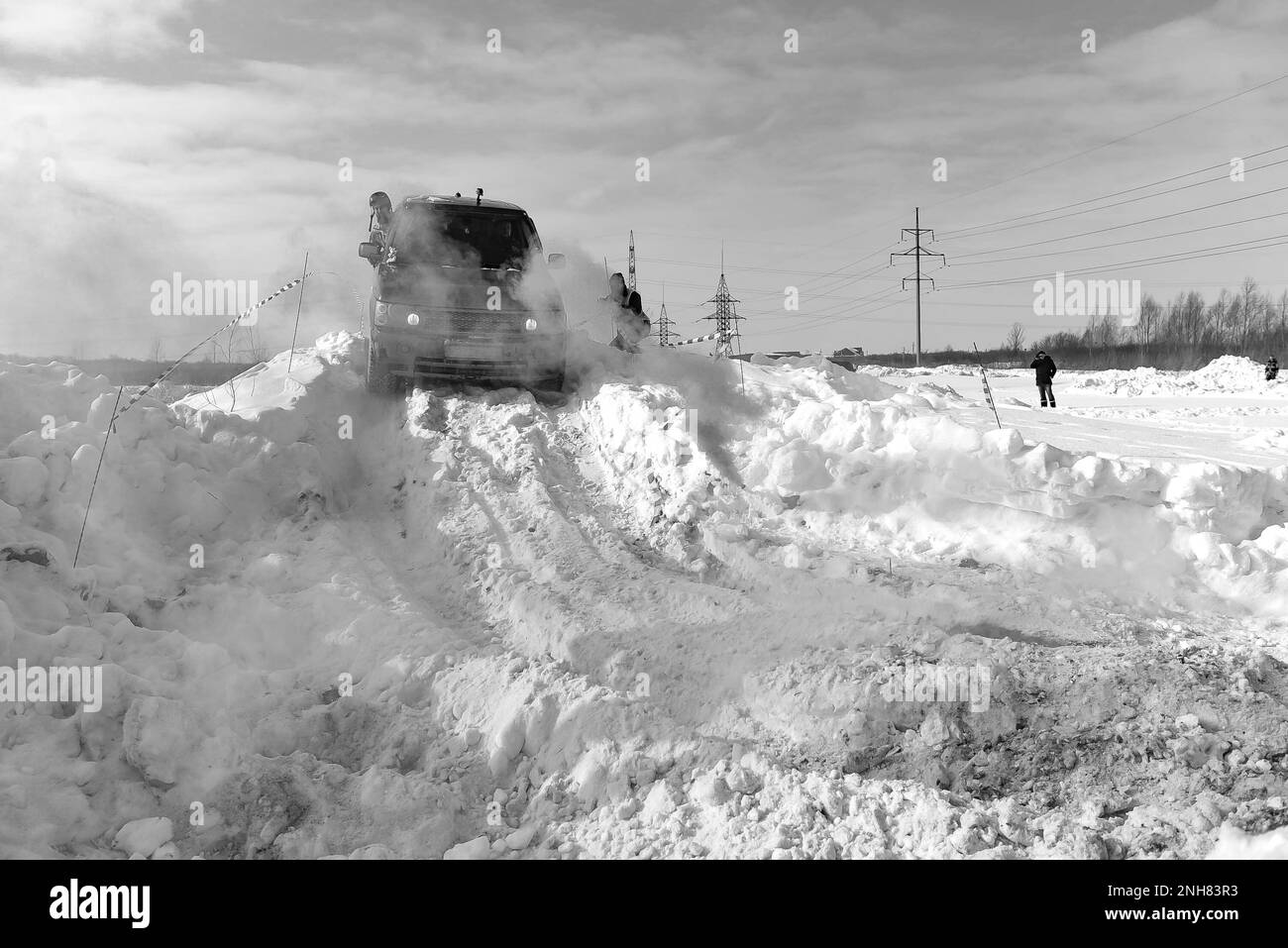 An off-road SUV "Range Rover 4x4" drives down a snowy mountain in ...