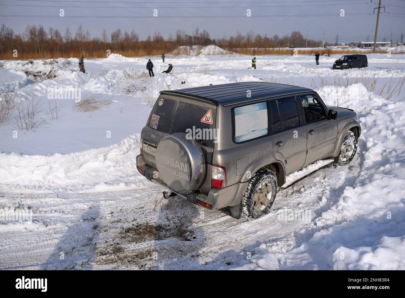 Offroad SUV "Nissan Patrol 4x4" quickly rides in the snow field in ...