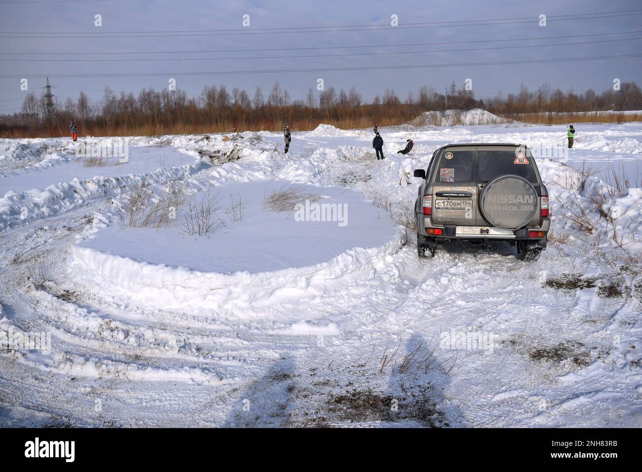 Offroad SUV "Nissan Patrol 4x4" quickly rides in the snow field in ...